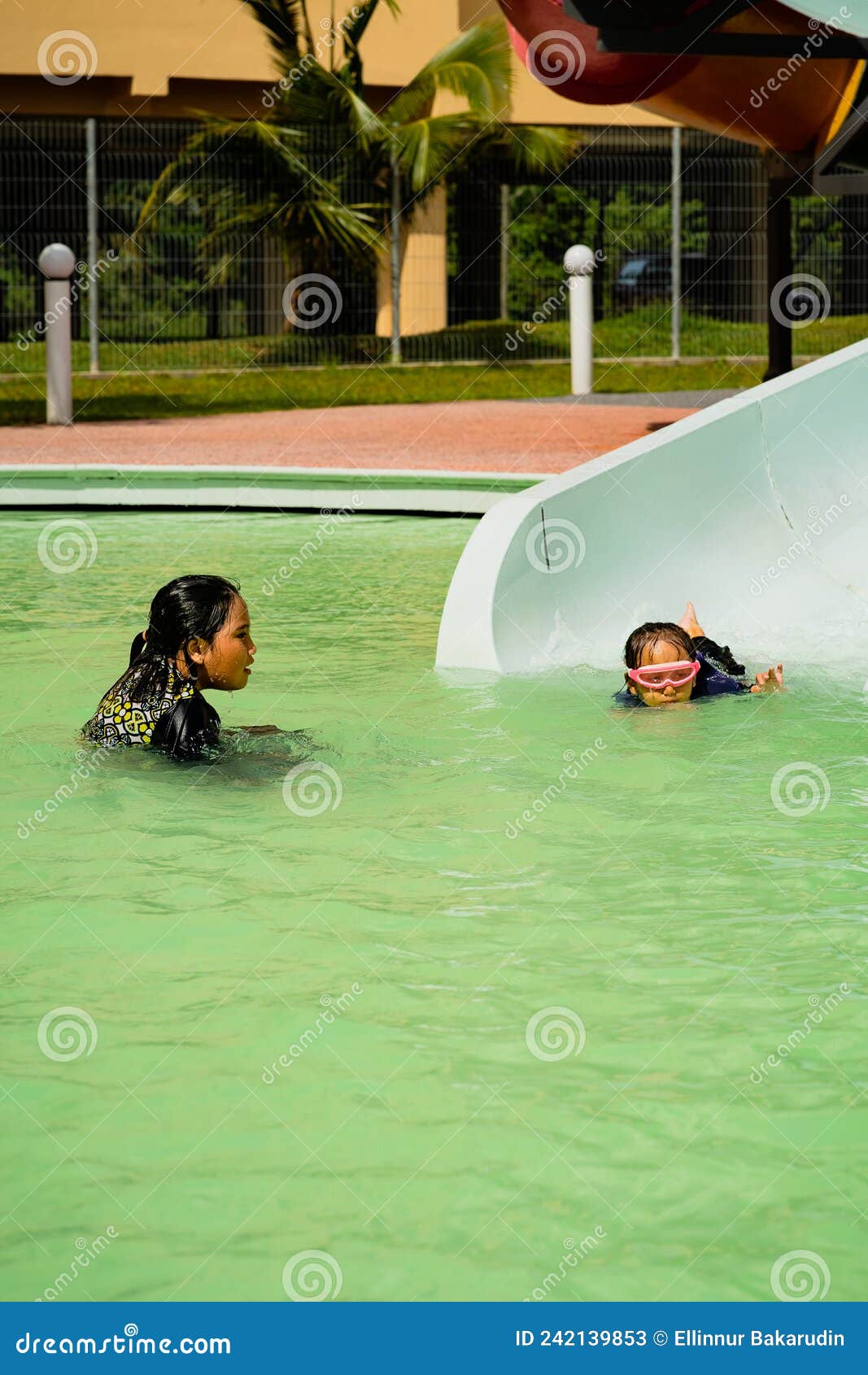 Children Sliding into Pool after Going Down Water Slide during Summer ...