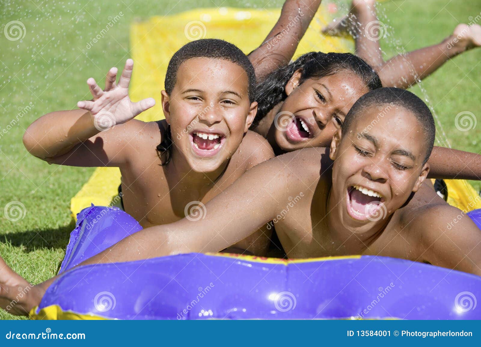 Teen Boy Sliding Down A Slip And Slide Outdoors Stock Photo ...