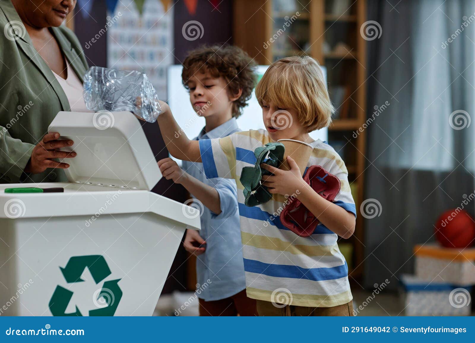 Children Sorting Plastic and Paper in Recycling Class at Preschool ...