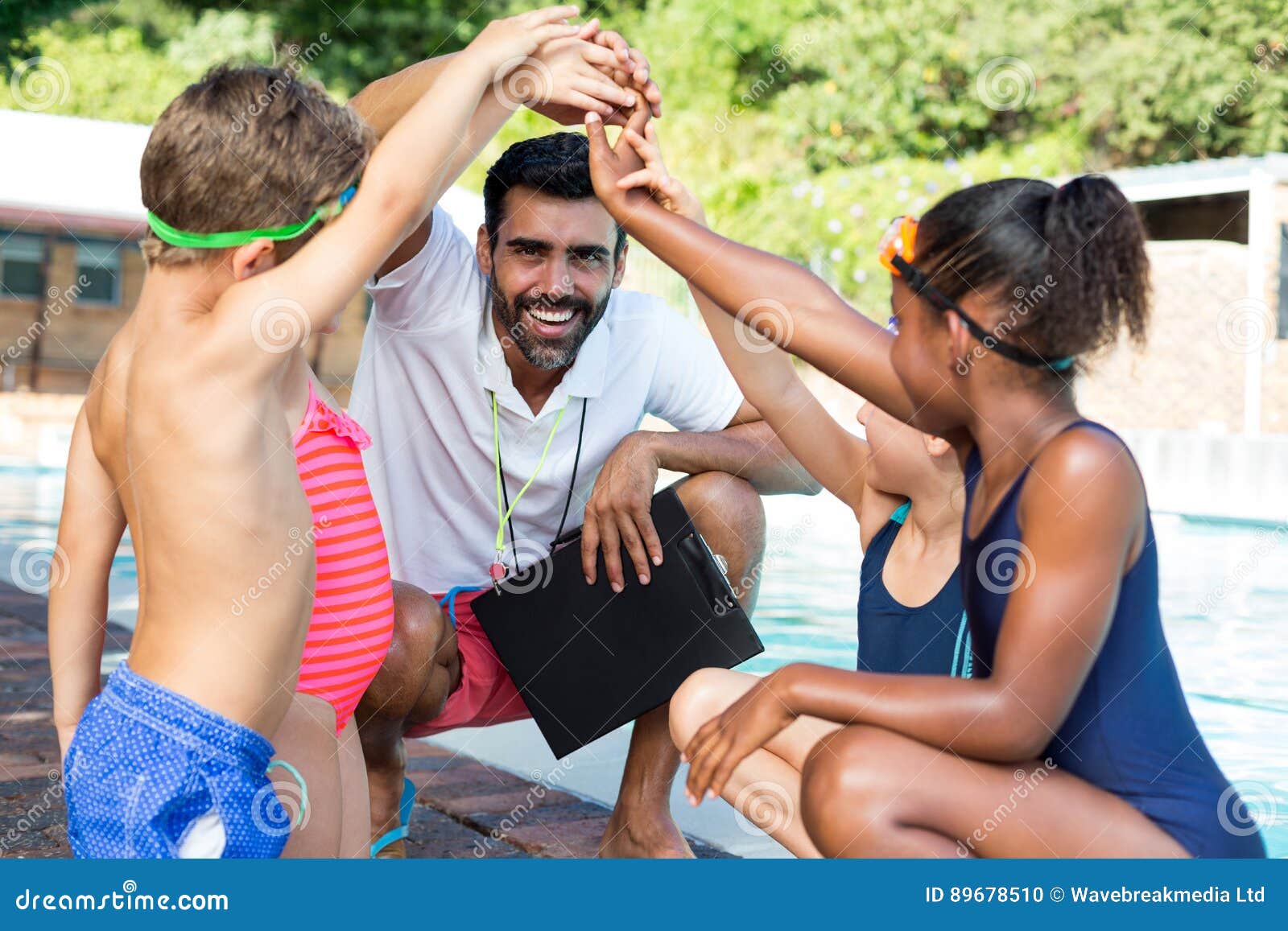Children Stacking Hands with Trainer at Poolside Stock Photo - Image of ...