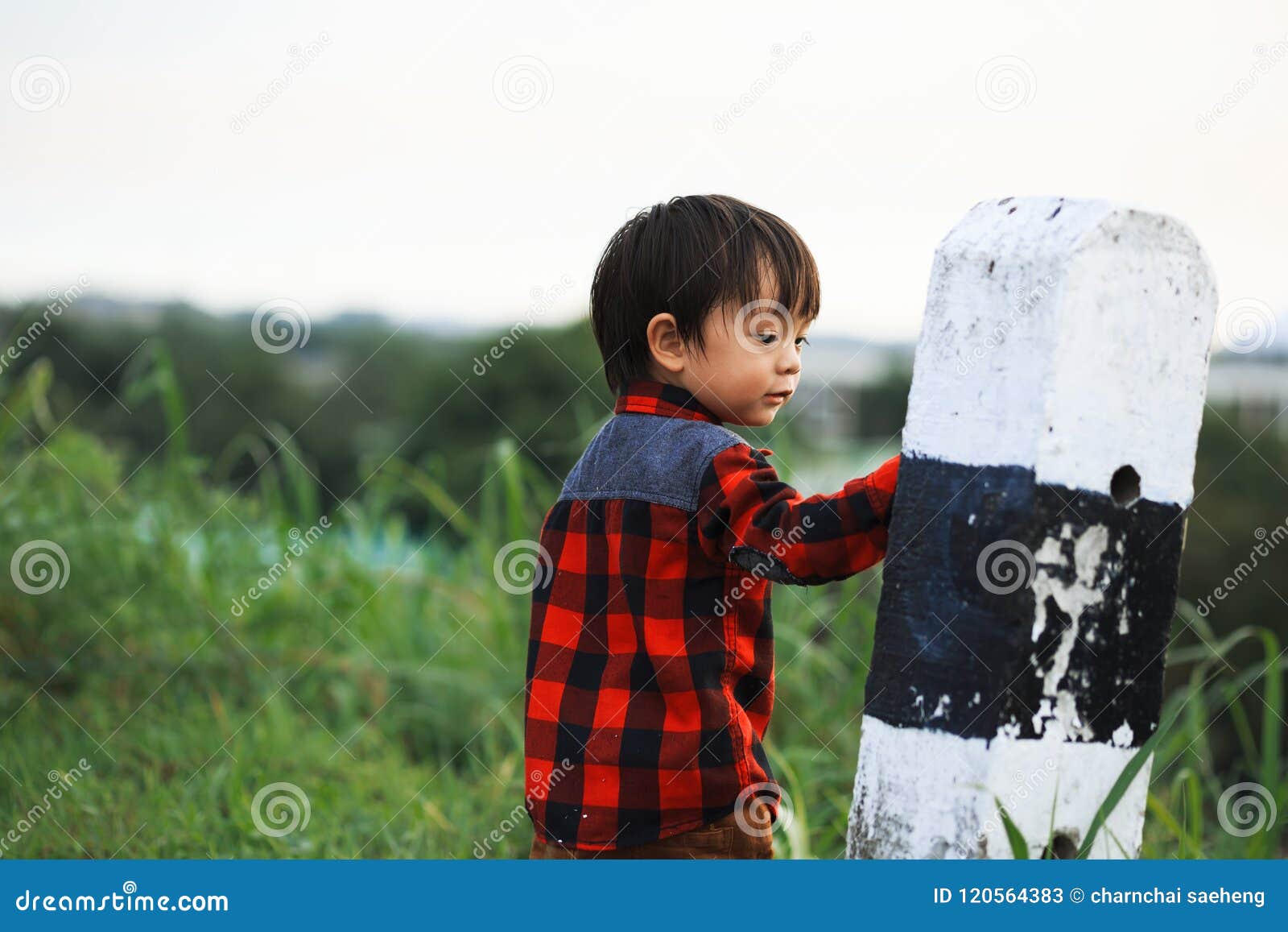The Children Stand Near the Pillar on the Road. Stock Image - Image of ...
