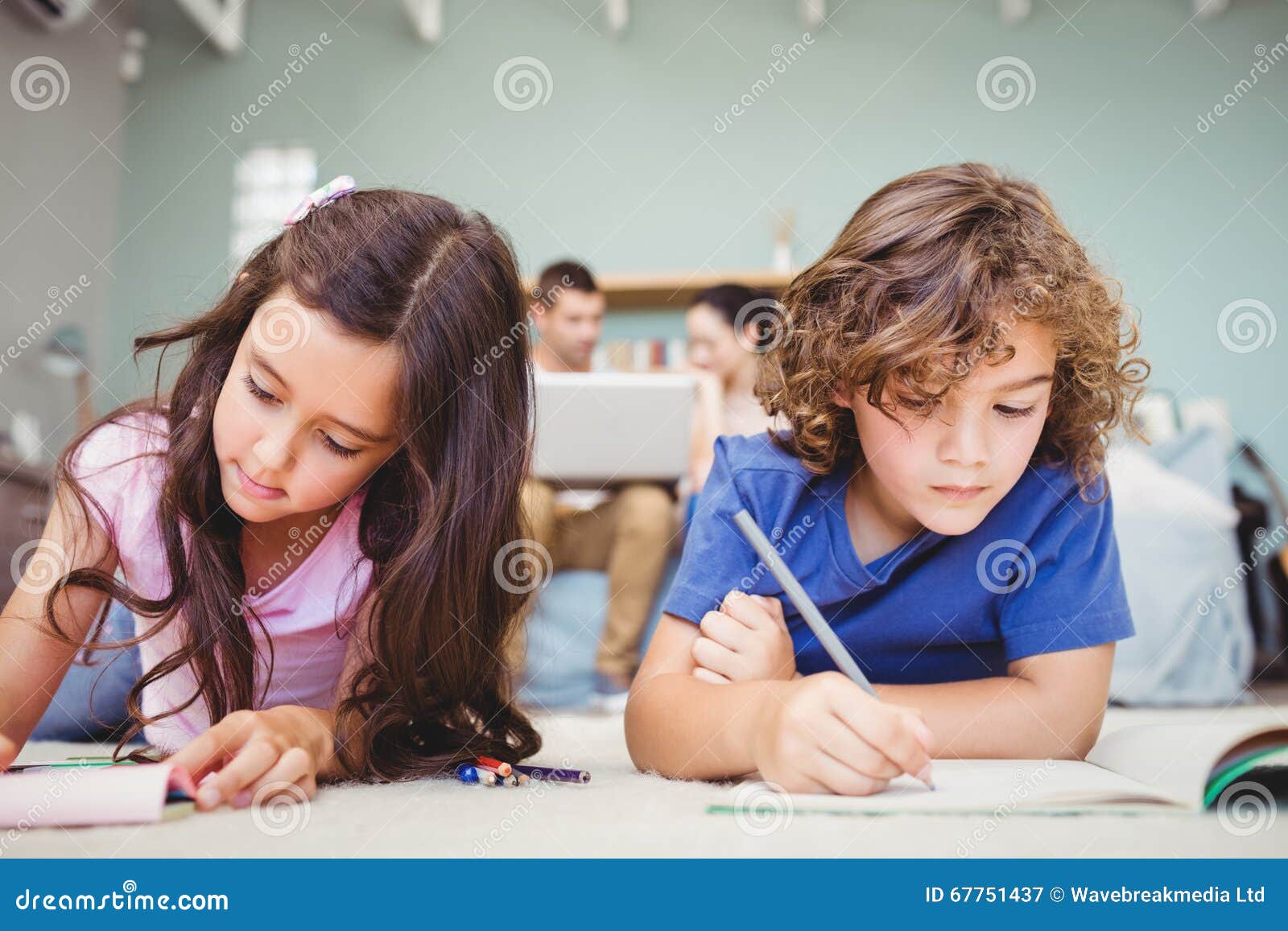 Children Studying while Parents in Background Stock Image - Image of ...