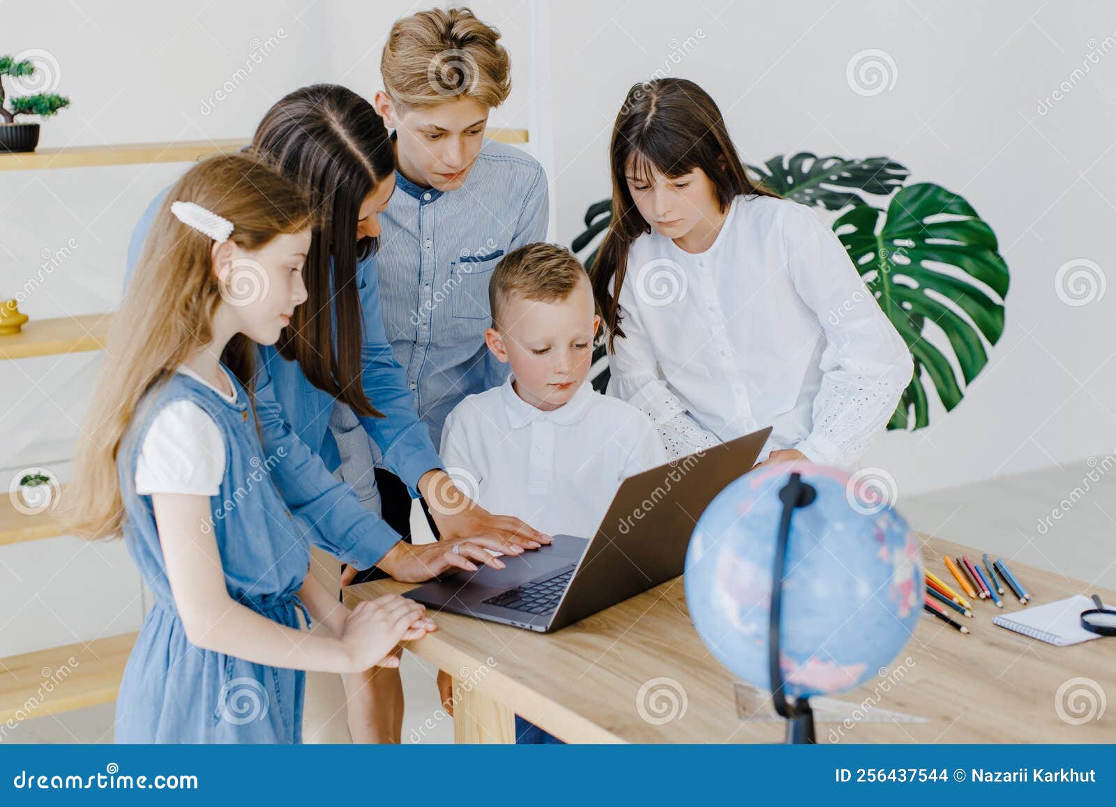Children and Teacher Looking at Laptop in the Classroom Stock Photo ...
