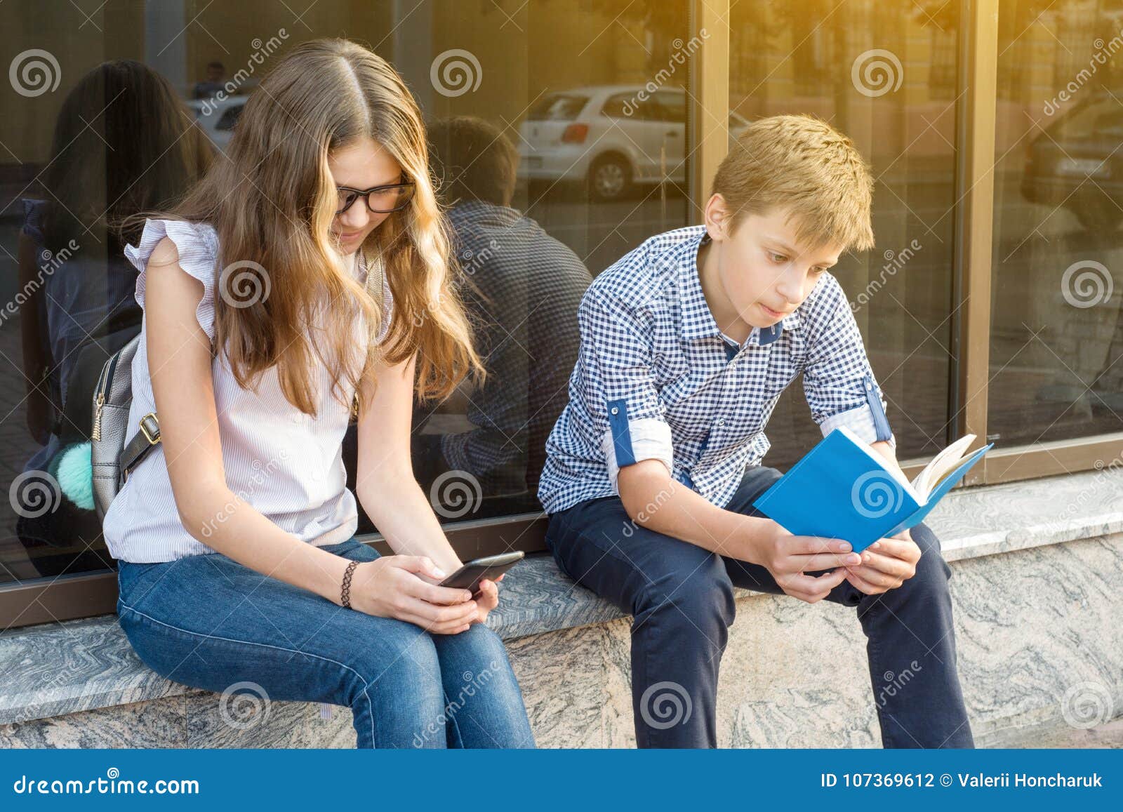 Children Teenagers, Break Reading Book Using Smartphone. Stock Photo ...