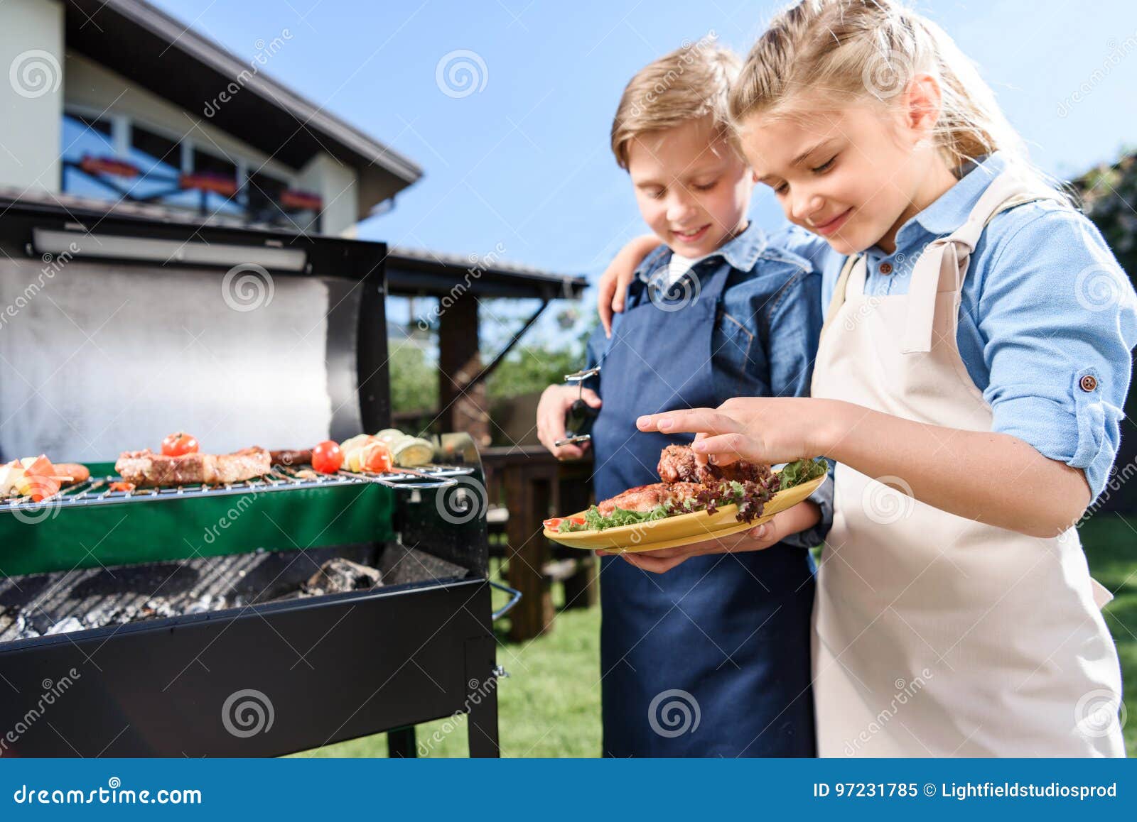 Children Testing Fresh Meat Just Cooked on Barbecue Grill Outdoors ...