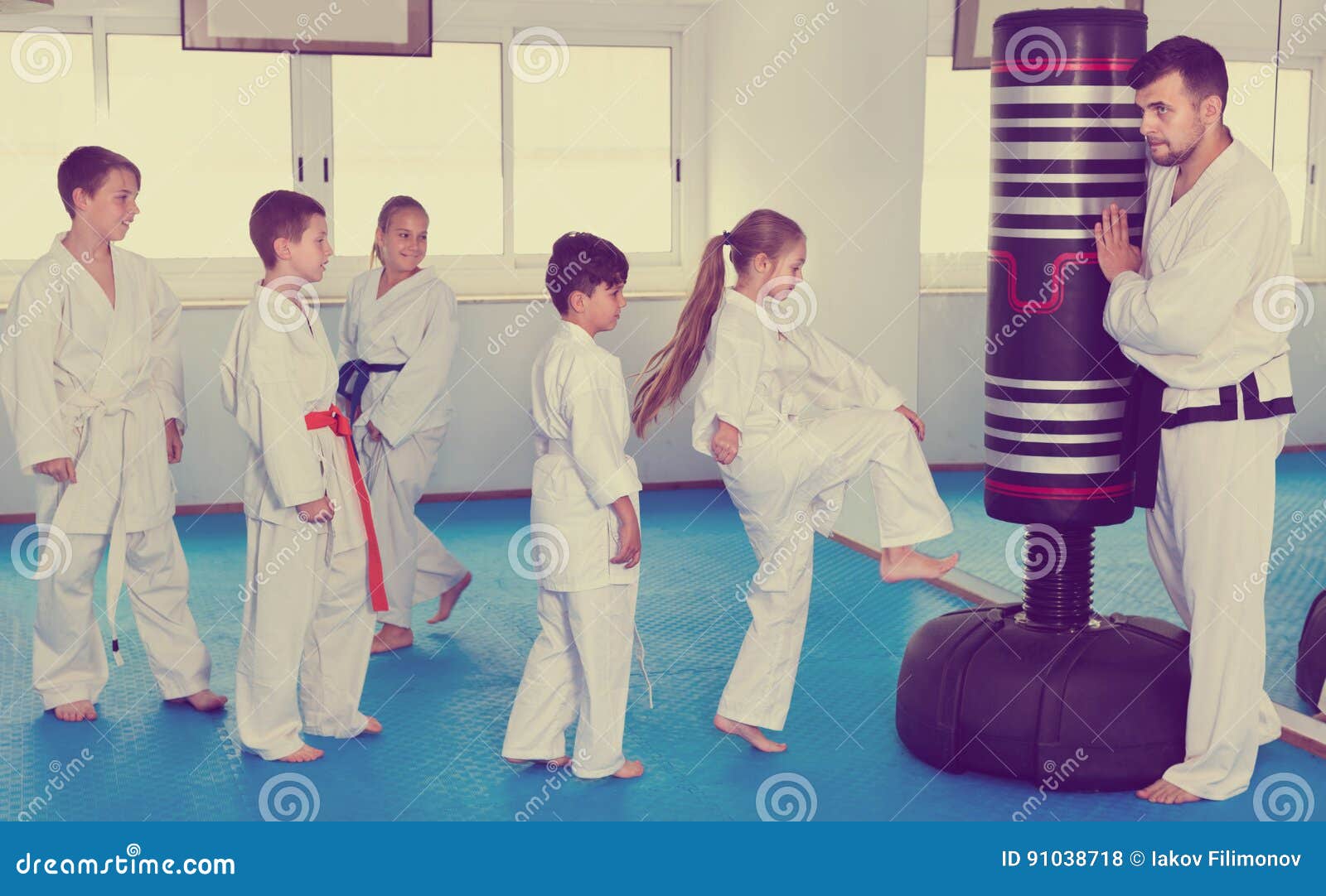Children Training Karate Kicks on Punching Bag during Karate Class ...