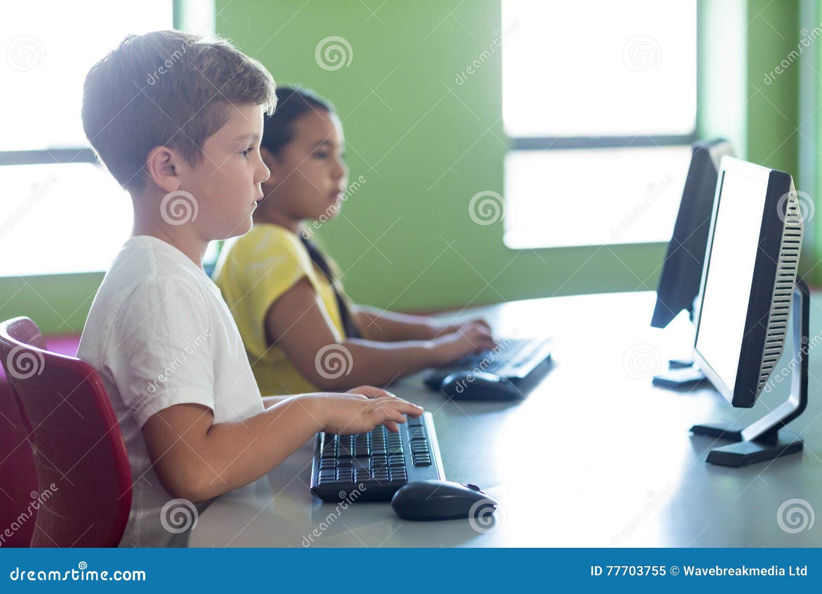Children using computers stock image. Image of elementary - 77703755