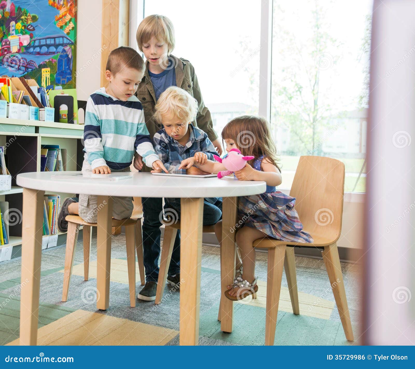 Children Using Digital Tablet in Library Stock Photo - Image of ...