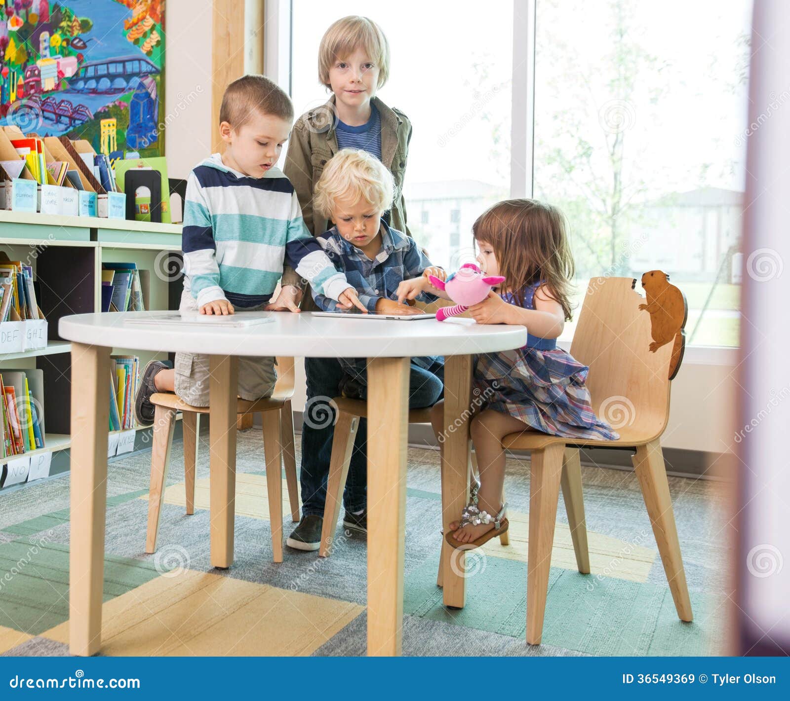 Children Using Digital Tablet at Table in Library Stock Image - Image ...