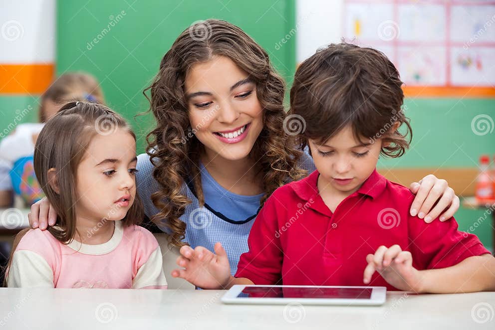Children Using Digital Tablet with Teacher Stock Image - Image of ...