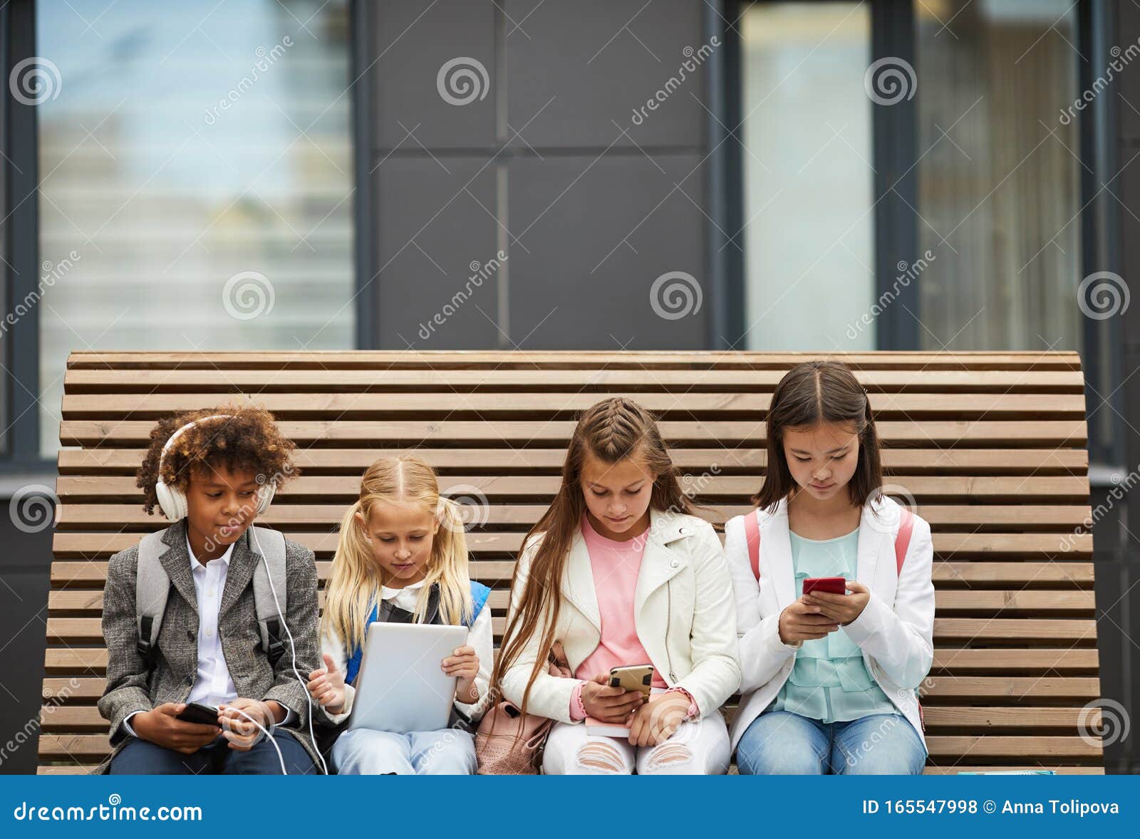 Children Using Gadgets Outdoors Stock Photo - Image of schoolboy, girls ...