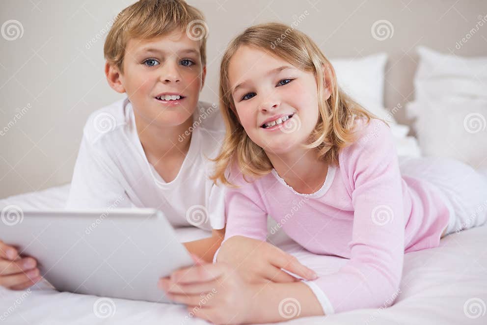 Children Using a Tablet Computer Stock Photo - Image of home, face ...