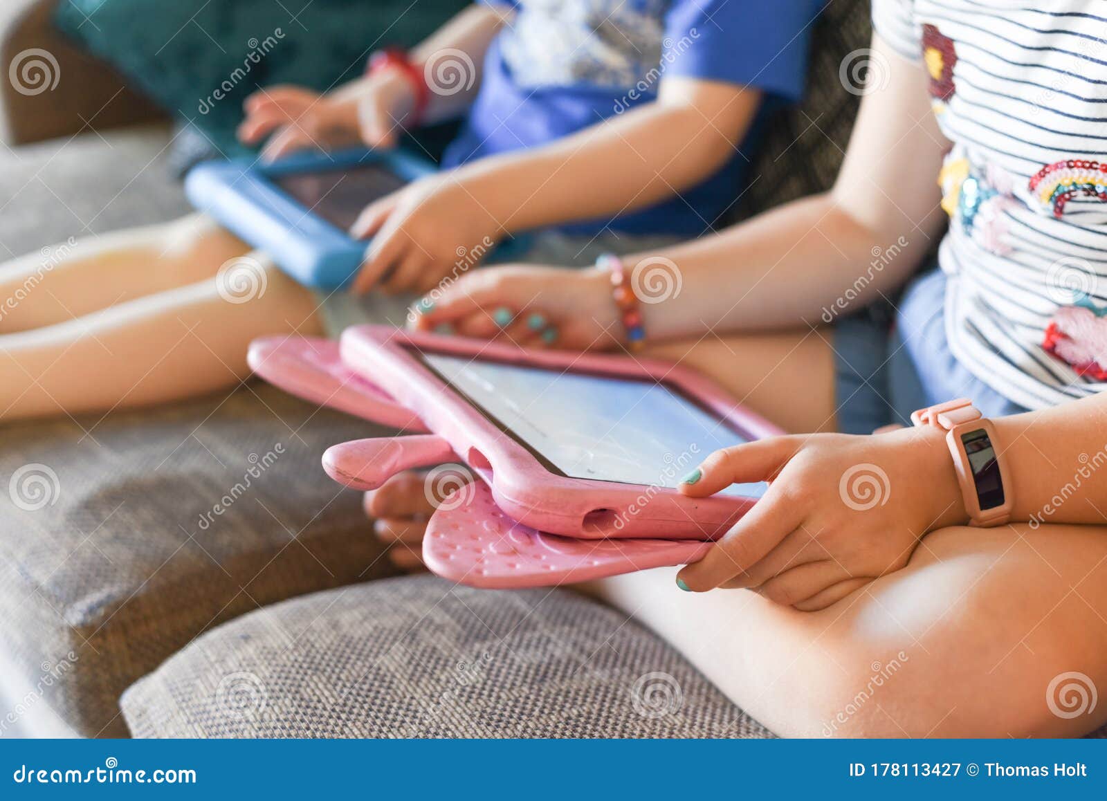Children Using Their Tablet Device To Play Computer Games and Use ...