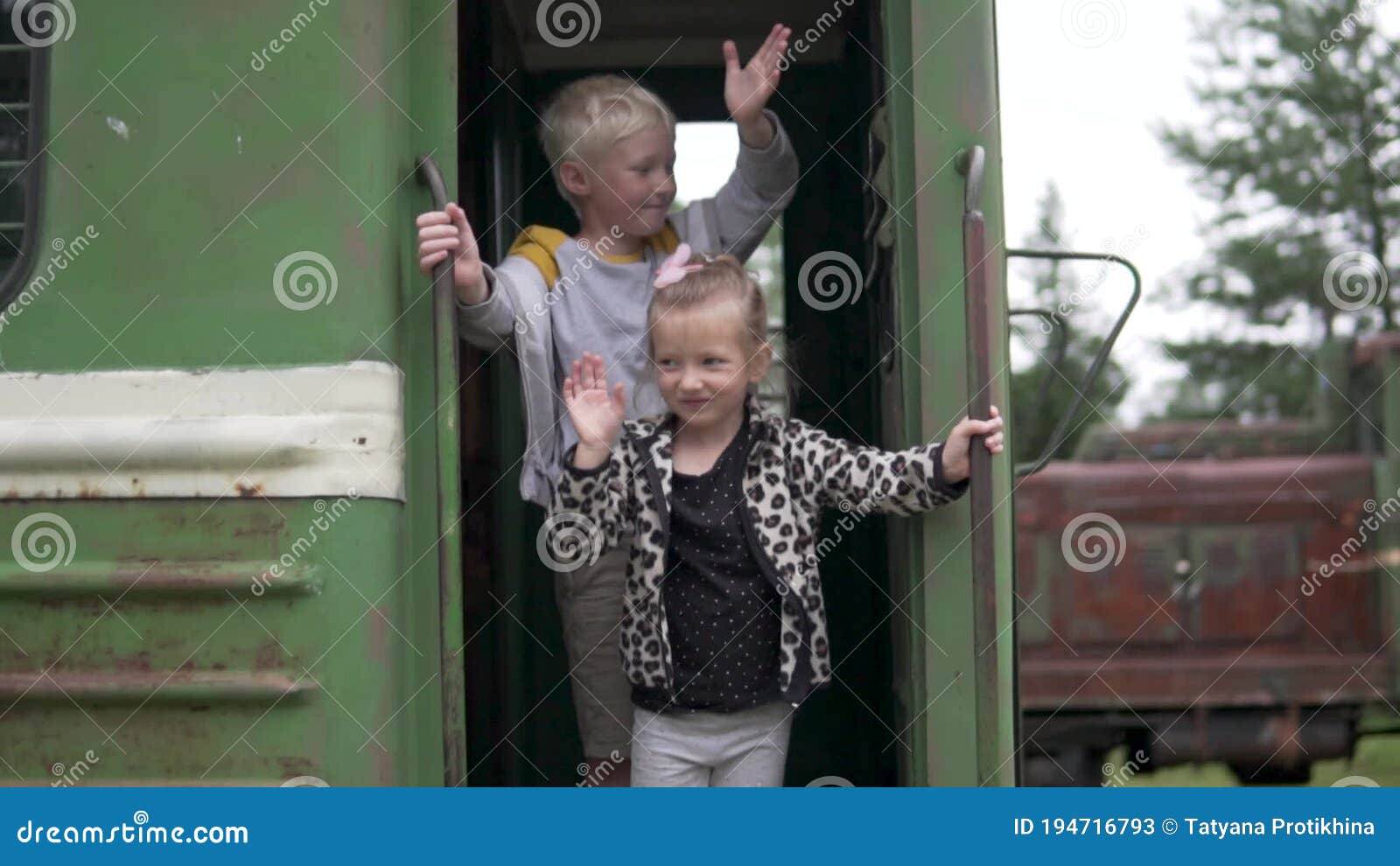 Children Wave Goodbye from the Last Carriage of the Departing Train ...