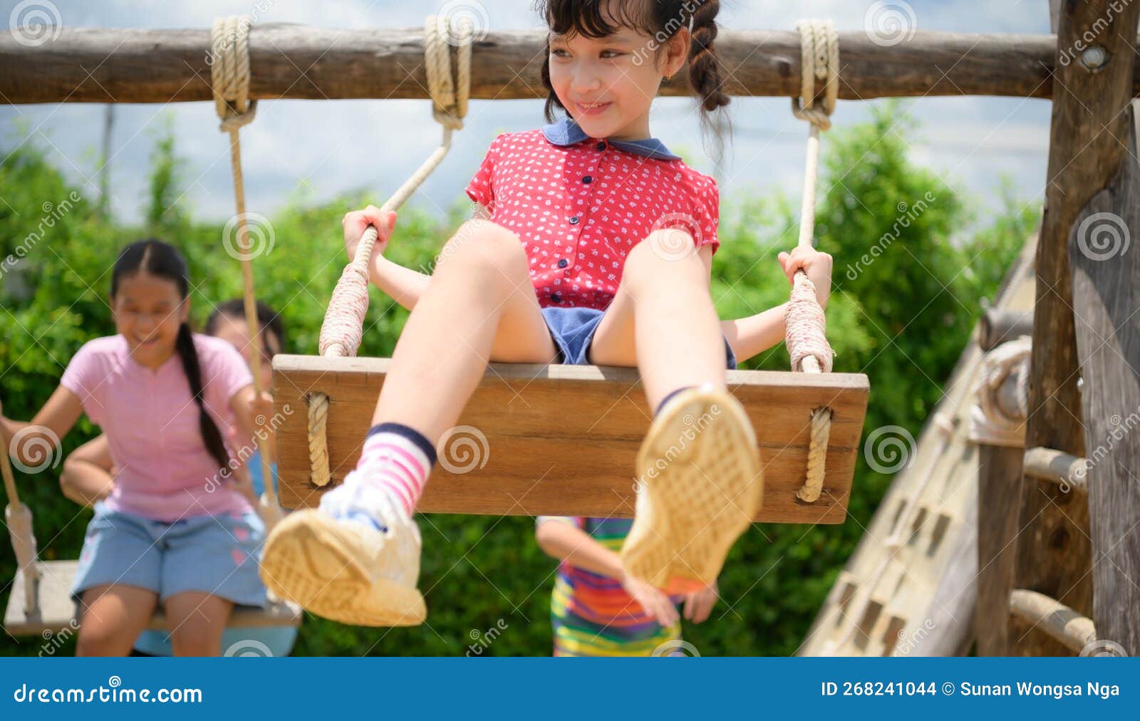Childrens Having Fun Swinging on a Swing on a Clear Day Stock Photo ...