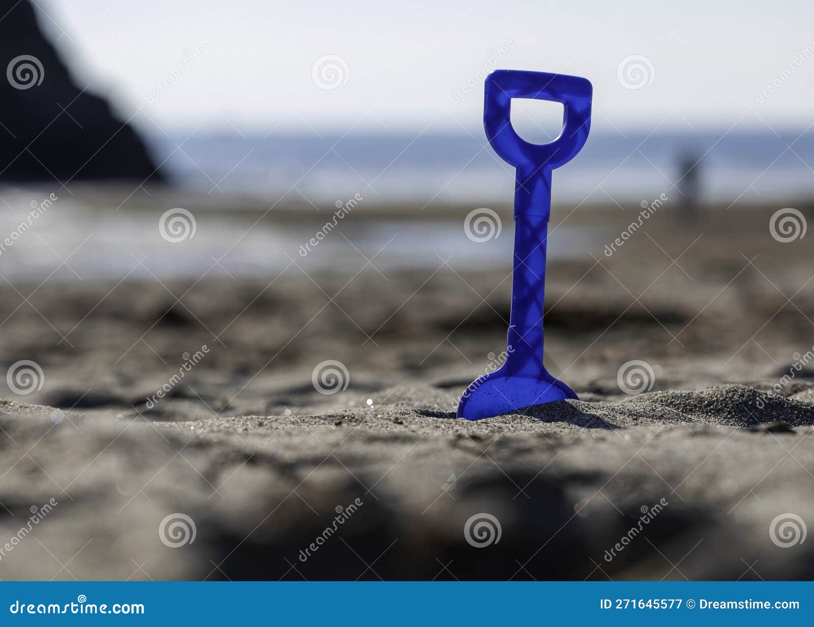 A blue spade on a beach stock image. Image of holiday - 271645577