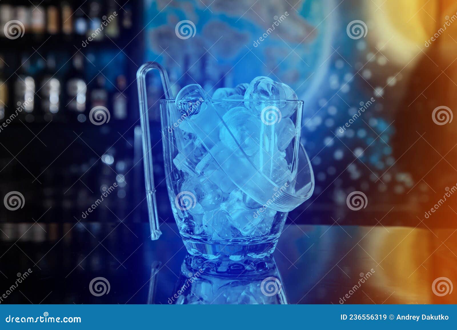 Chilled Ice Cookware with Ice Cubes and Plastic Tongs on the Bar ...