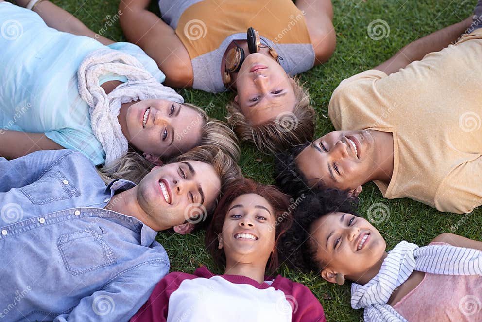 Chilling after Class. a Group of Young Students Lying on the Grass on ...