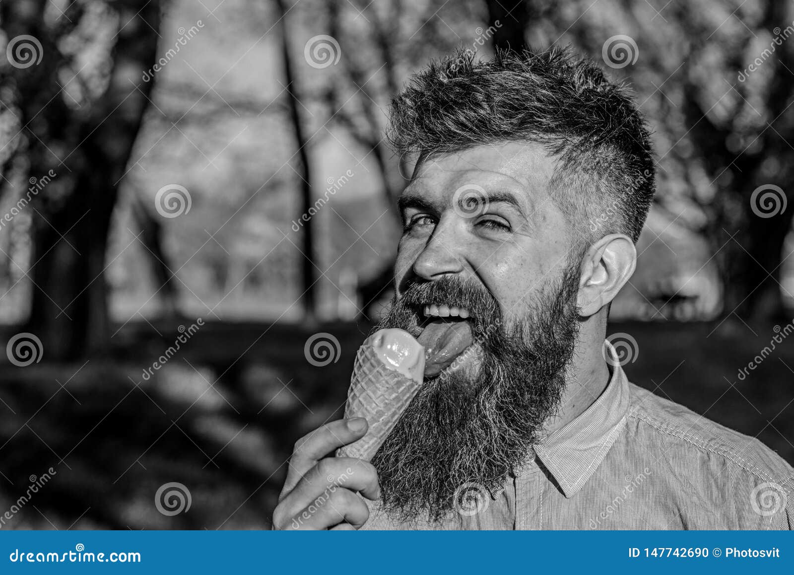 Chilling Concept Man With Long Beard Licks Ice Cream Close Up