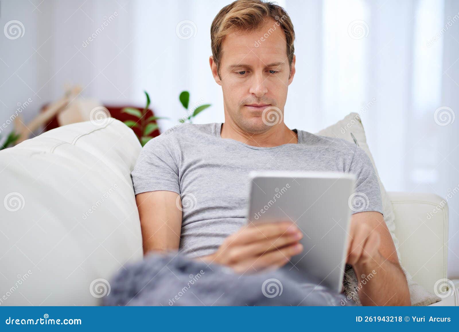Chilling on the Sofa with His Tech. a Handsome Man Relaxing with His ...