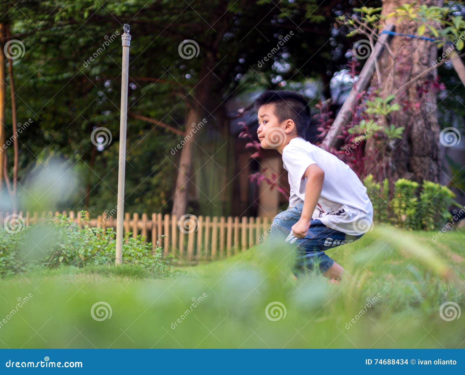 Chinese Child (boy) Crouch on the Park Stock Photo - Image of 6years ...
