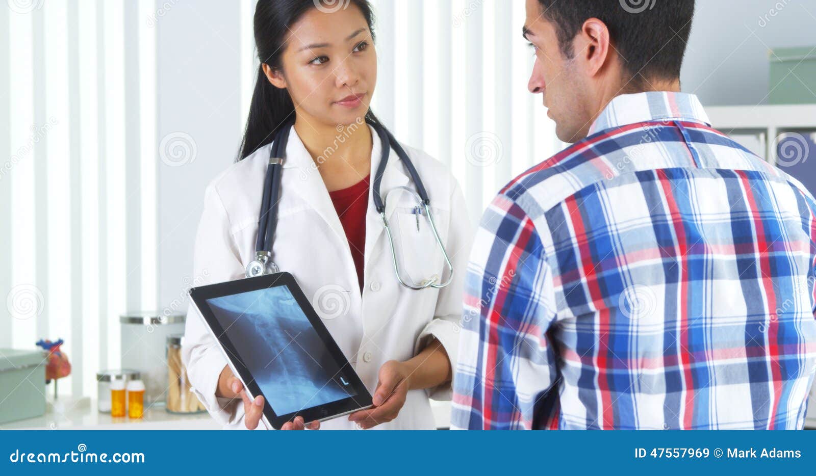 Chinese Doctor Going Over Xray with Patient Stock Image - Image of ...