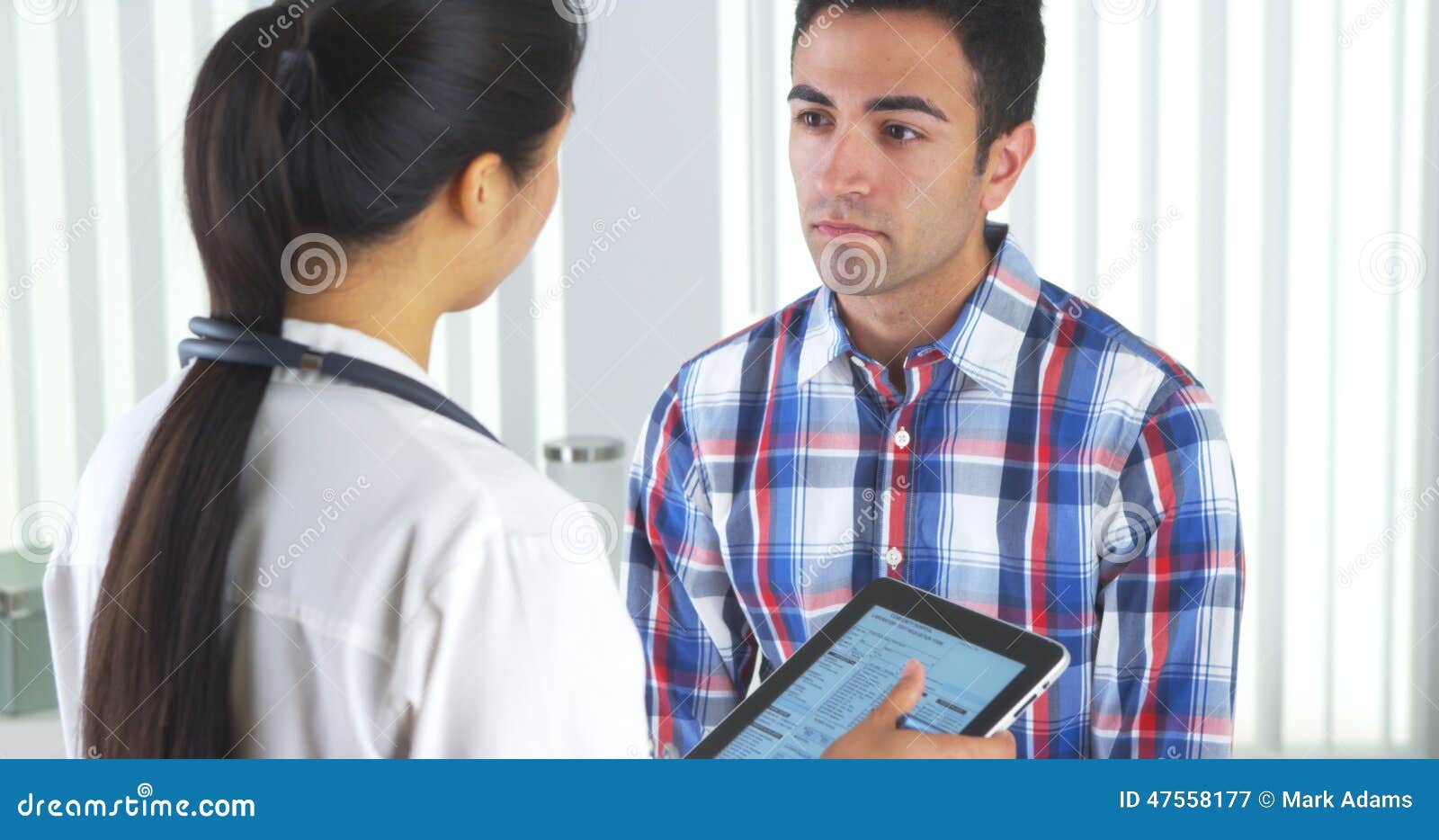Chinese Doctor Talking To Patient and Taking Notes Stock Image - Image ...