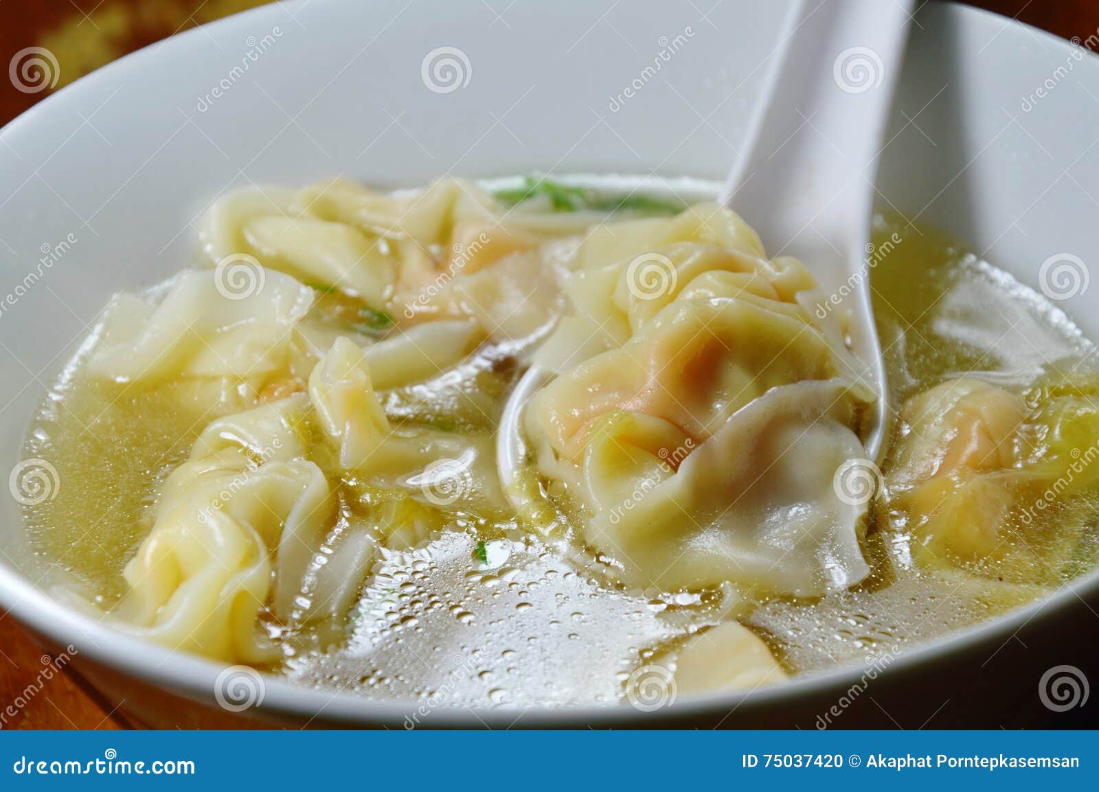 Chinese Dumpling in Clear Soup on Spoon Stock Photo - Image of ...