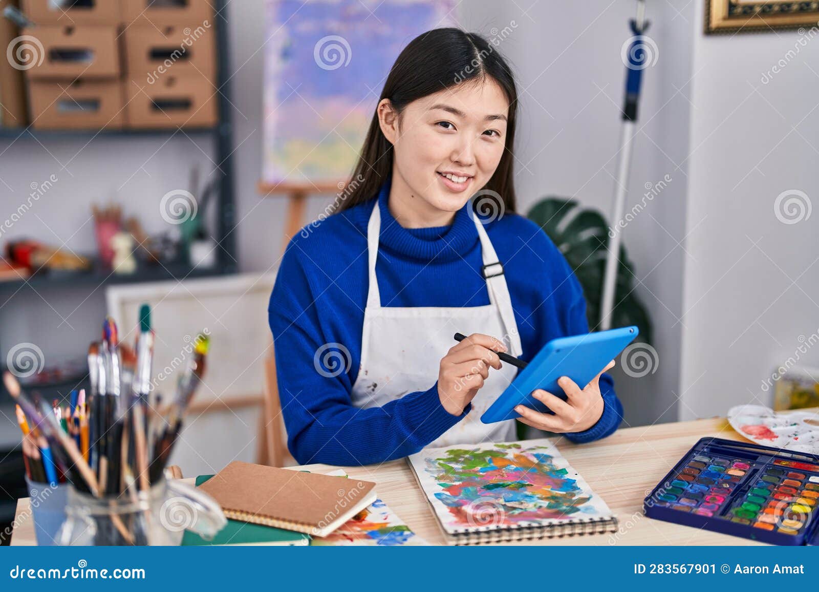 Chinese Woman Artist Using Touchpad Drawing on Notebook at Art Studio ...