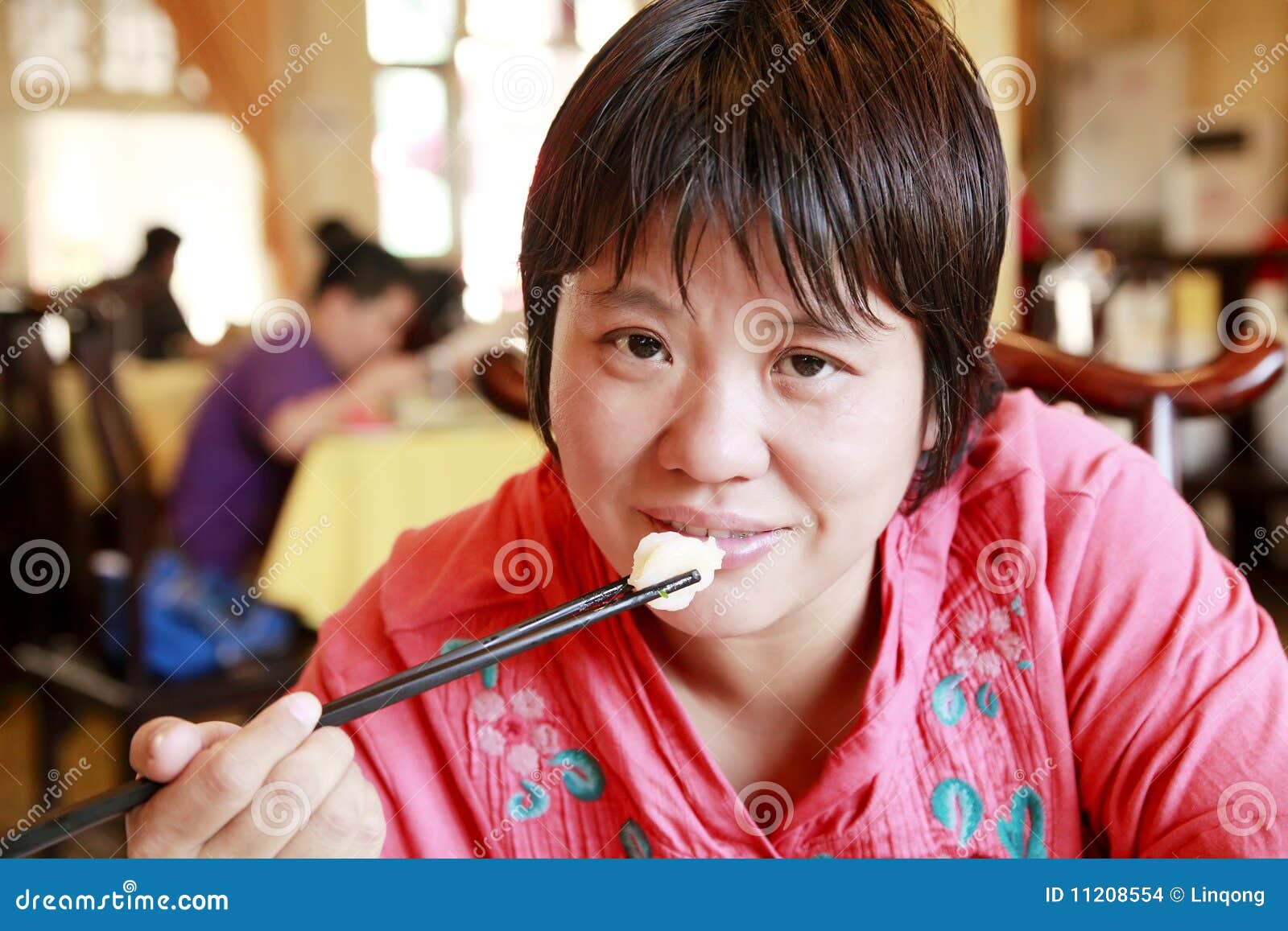 Chinese woman eating meal stock photo. Image of room - 11208554