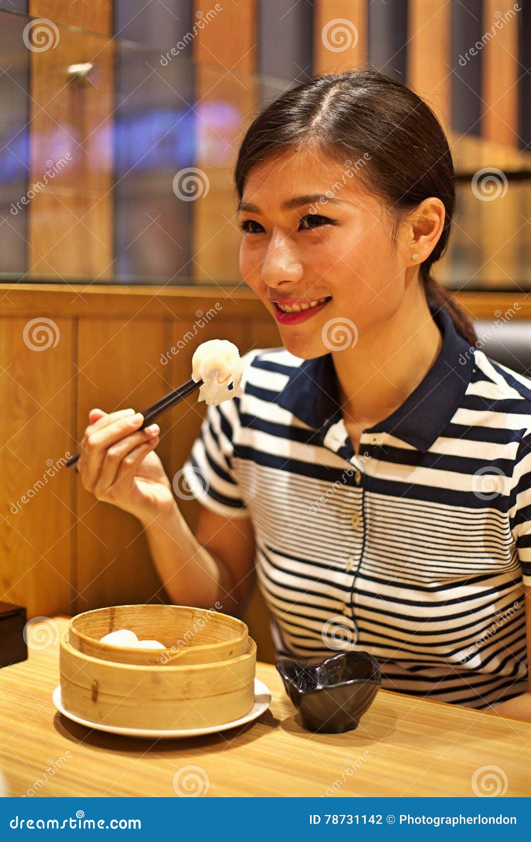Chinese Woman Eating Steamed Dumpling in Restaurant Stock Photo - Image ...