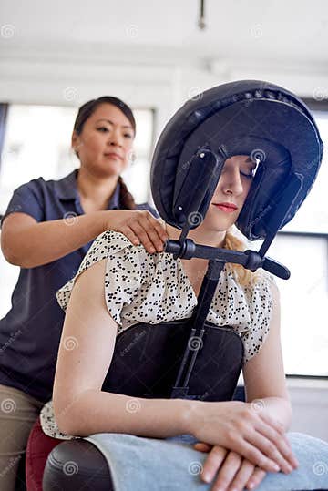 Chinese Woman Massage Therapist Giving A Neck And Back Pressure