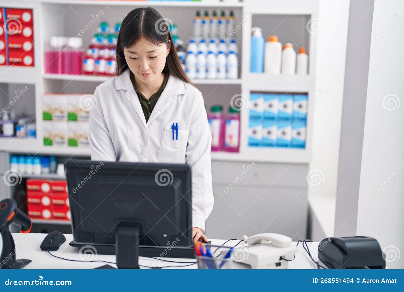 Chinese Woman Pharmacist Using Computer Working at Pharmacy Stock Photo ...