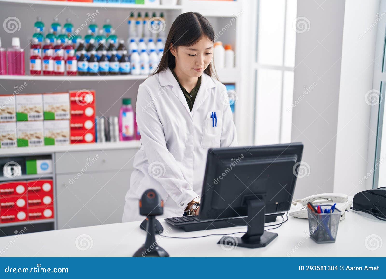 Chinese Woman Pharmacist Using Computer Working at Pharmacy Stock Photo ...