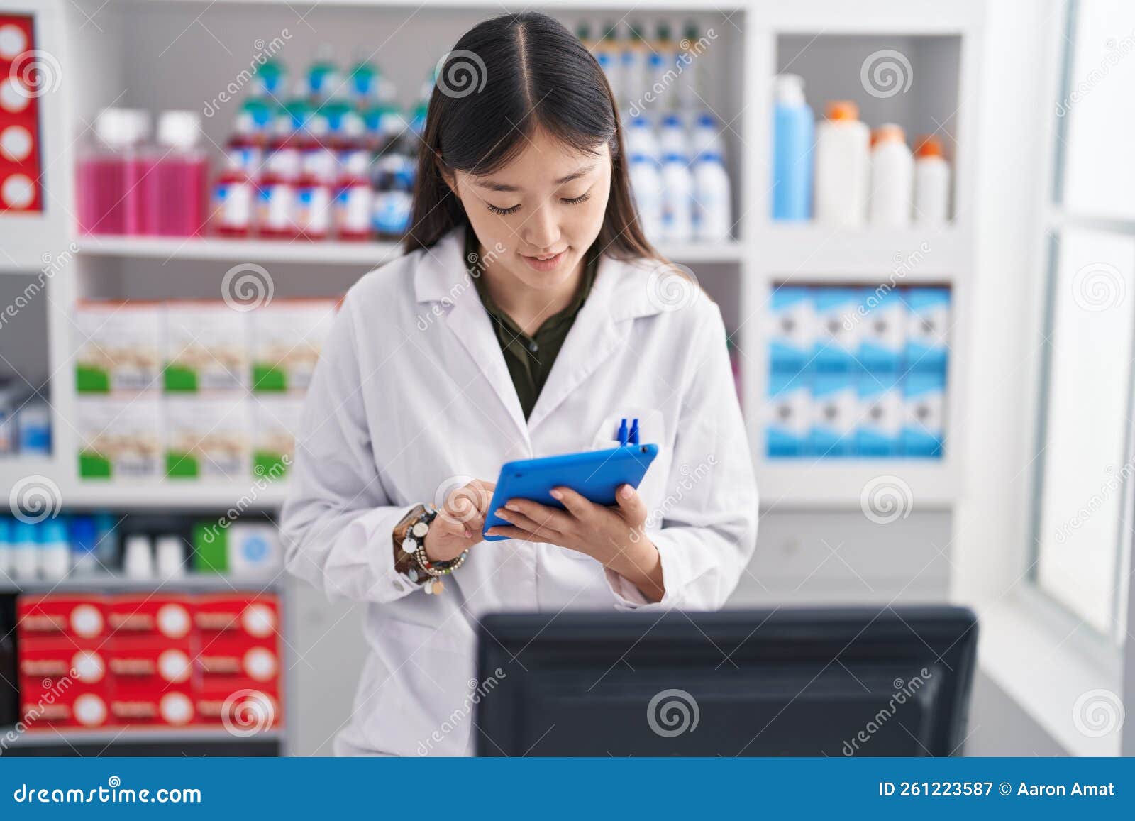 Chinese Woman Pharmacist Using Touchpad Working at Pharmacy Stock Image ...