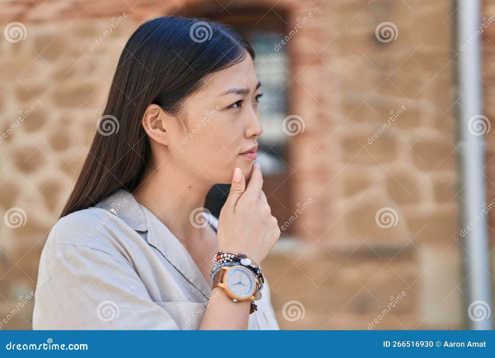 Chinese Woman Standing with Doubt Expression at Street Stock Photo ...