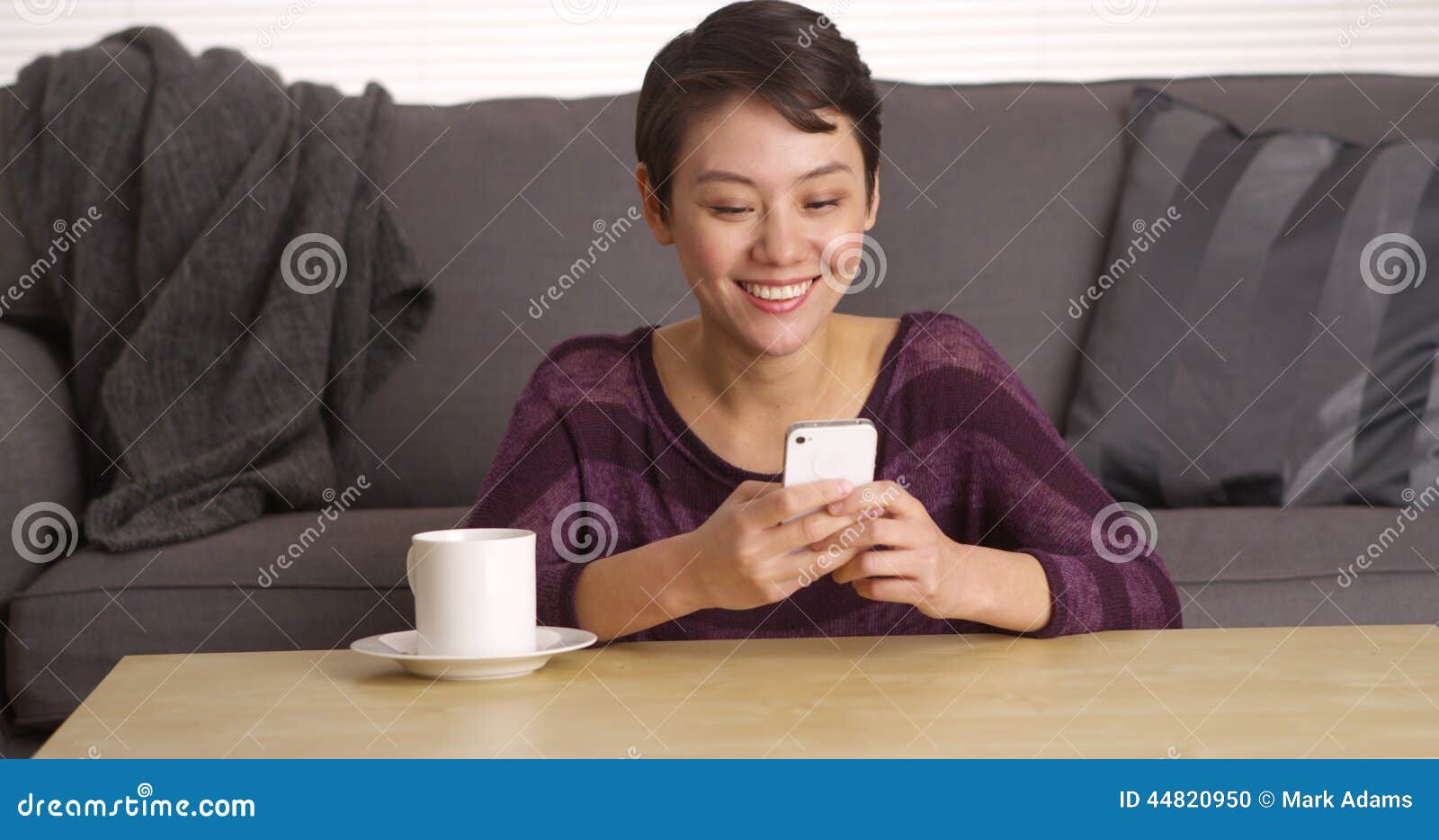 Chinese Woman Texting on Smartphone by Coffee Table Stock Photo - Image ...