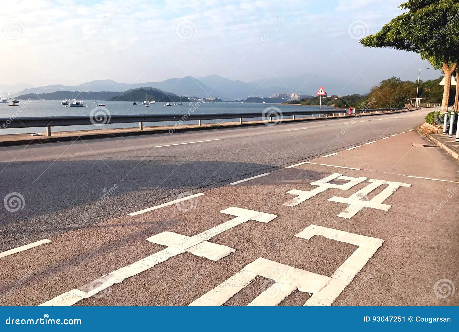 Chinese Word Bus Stop on Road with Ocean, Mountain and Sky Stock Image ...