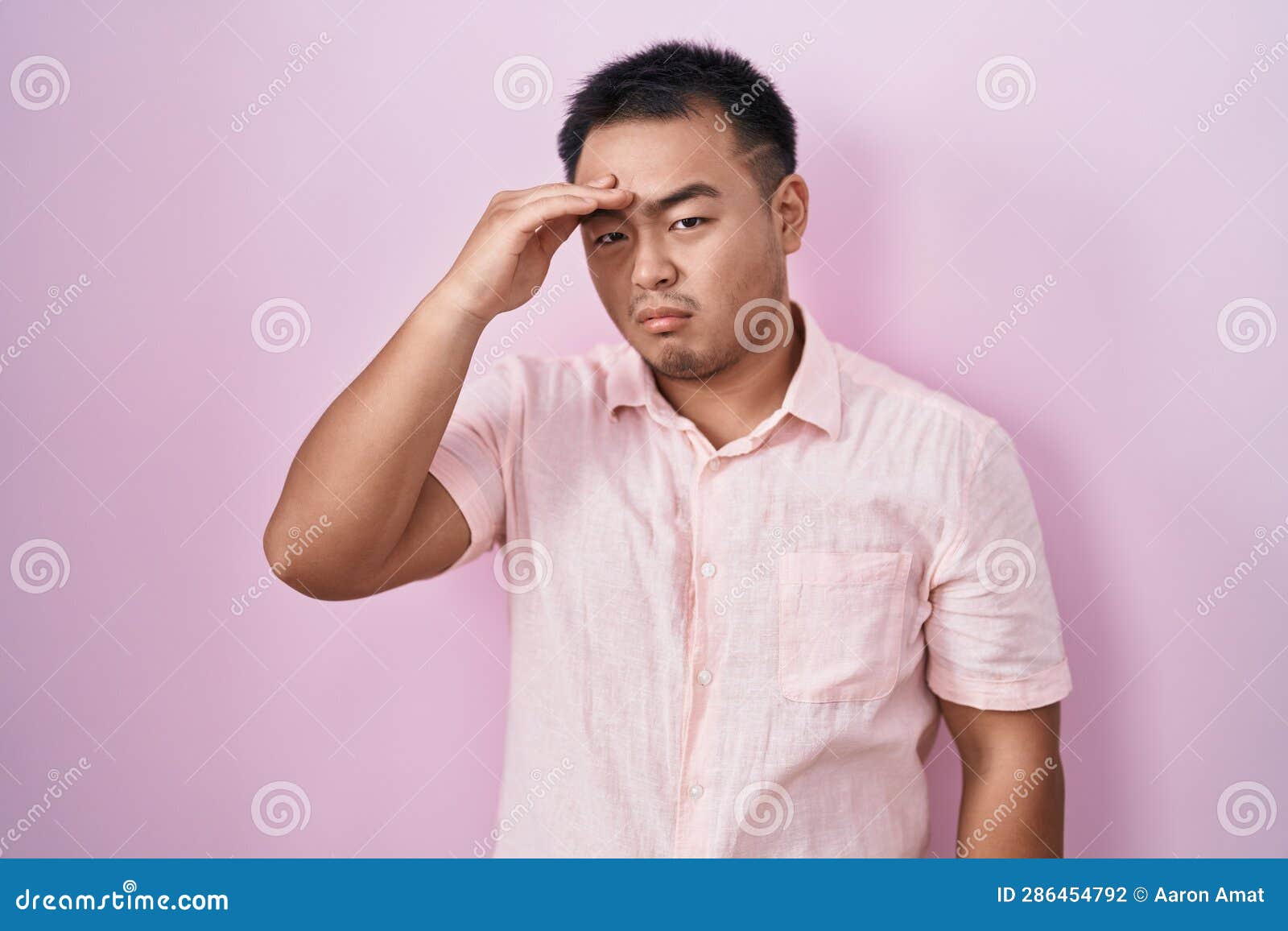 Chinese Young Man Standing Over Pink Background Worried and Stressed ...