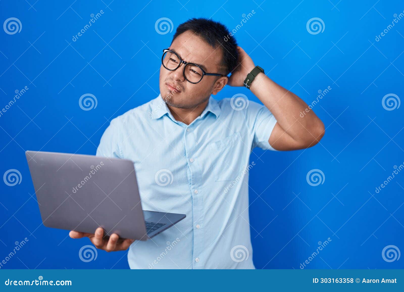 Chinese Young Man Using Computer Laptop Confuse and Wondering about ...