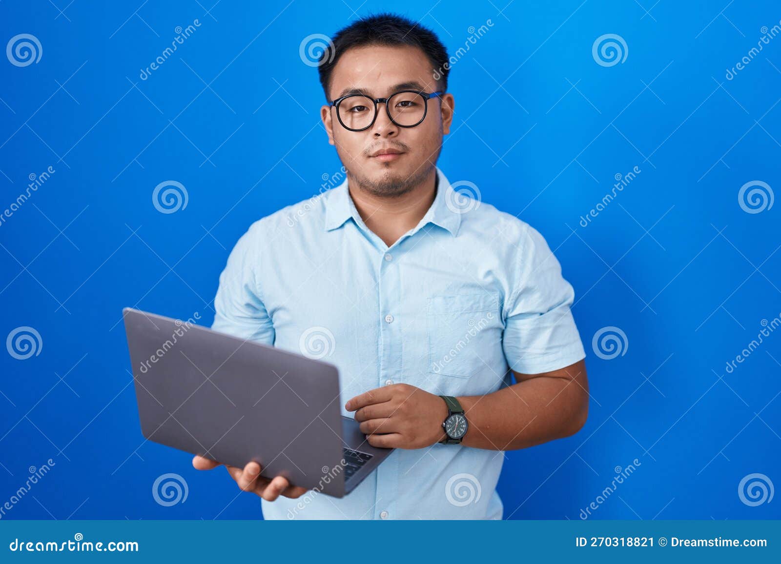 Chinese Young Man Using Computer Laptop Relaxed with Serious Expression ...
