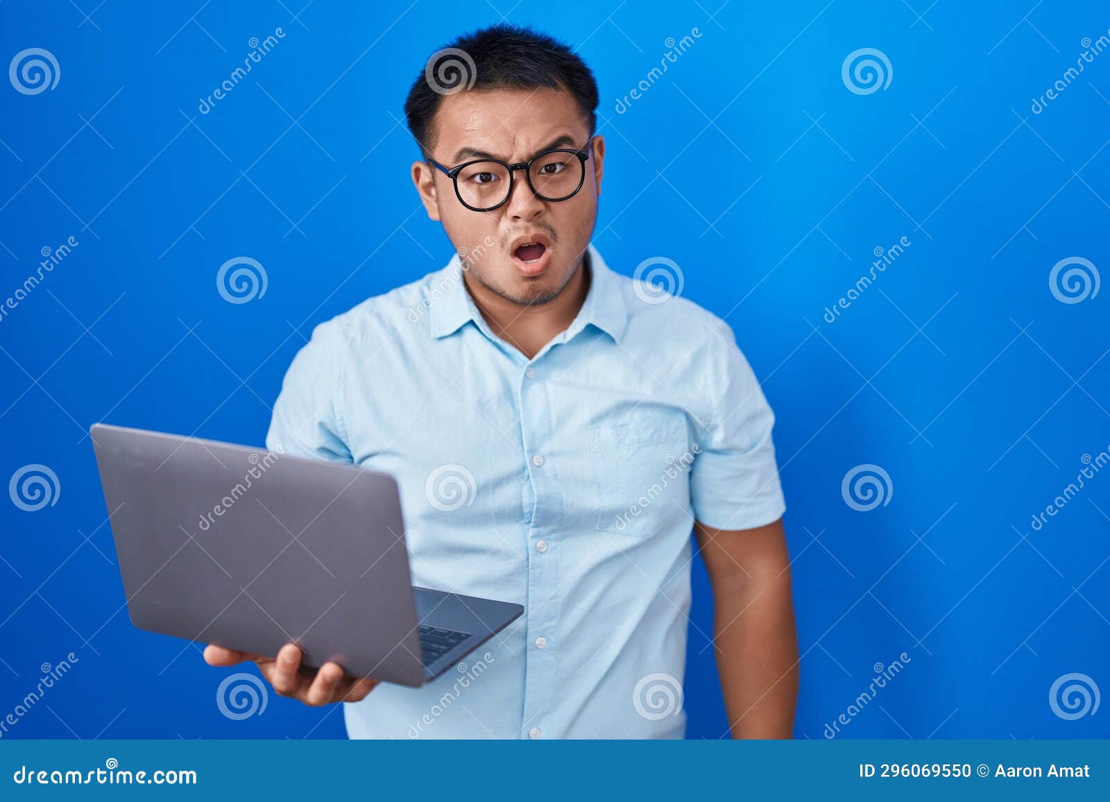 Chinese Young Man Using Computer Laptop in Shock Face, Looking ...