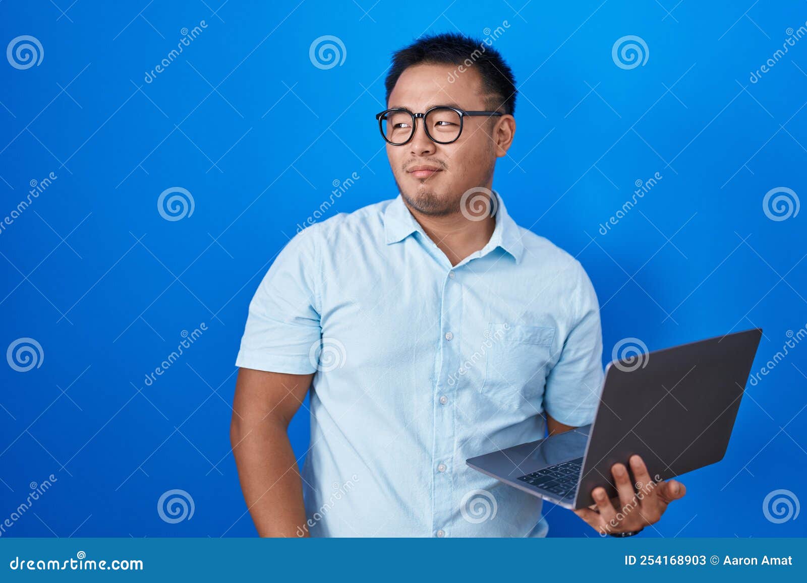 Chinese Young Man Using Computer Laptop Smiling Looking To the Side and ...