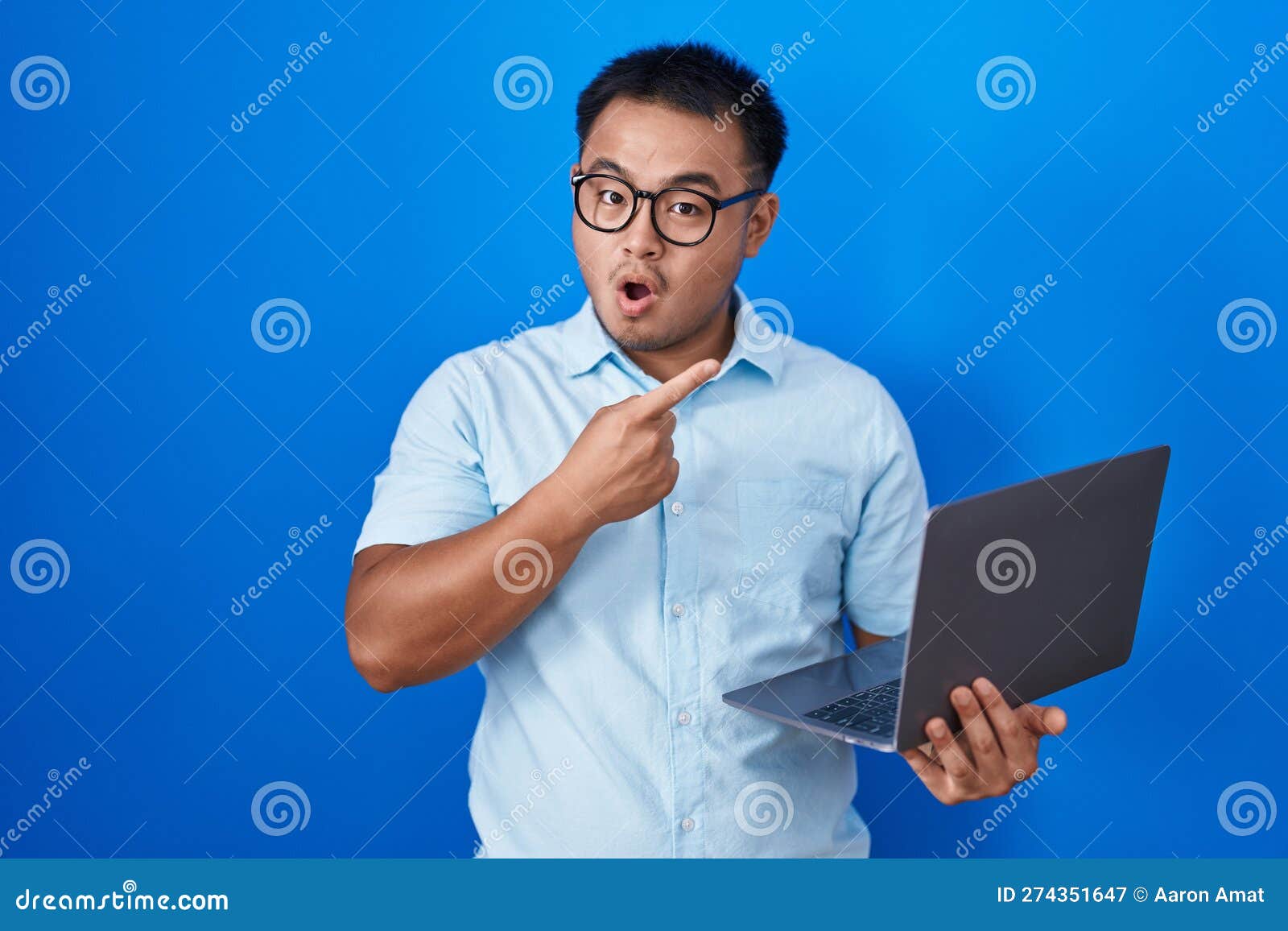 Chinese Young Man Using Computer Laptop Surprised Pointing with Finger ...
