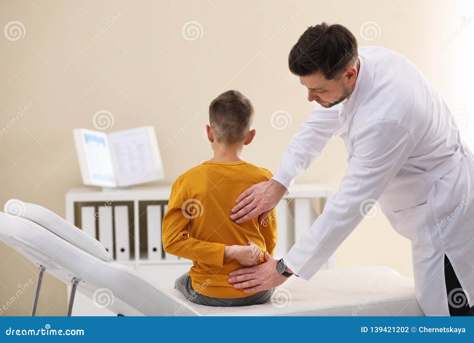 Chiropractor Examining Child with Back Pain Stock Photo - Image of ...