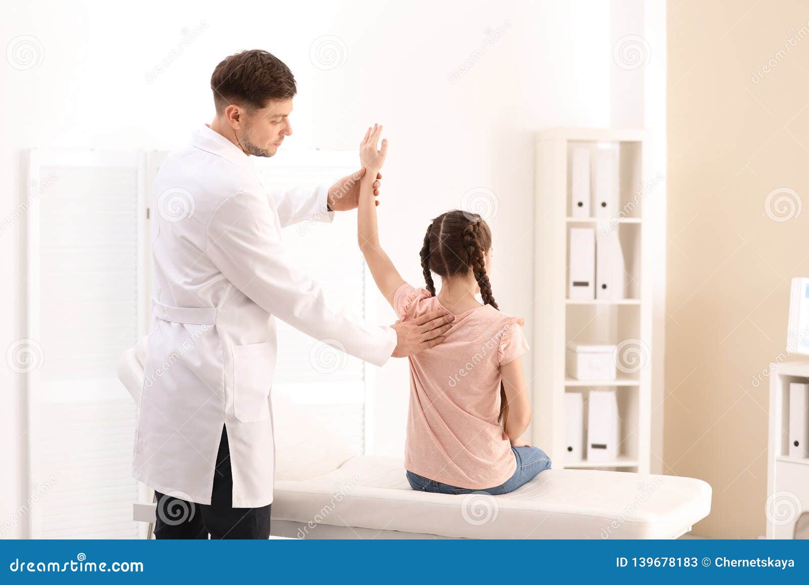 Chiropractor Examining Child with Back Pain Stock Image - Image of ...