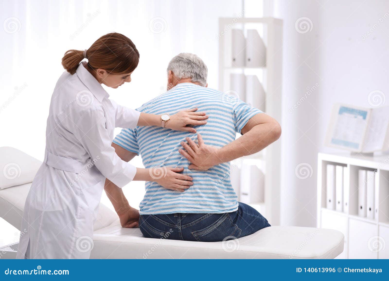Chiropractor Examining Patient with Back Pain Stock Photo - Image of ...