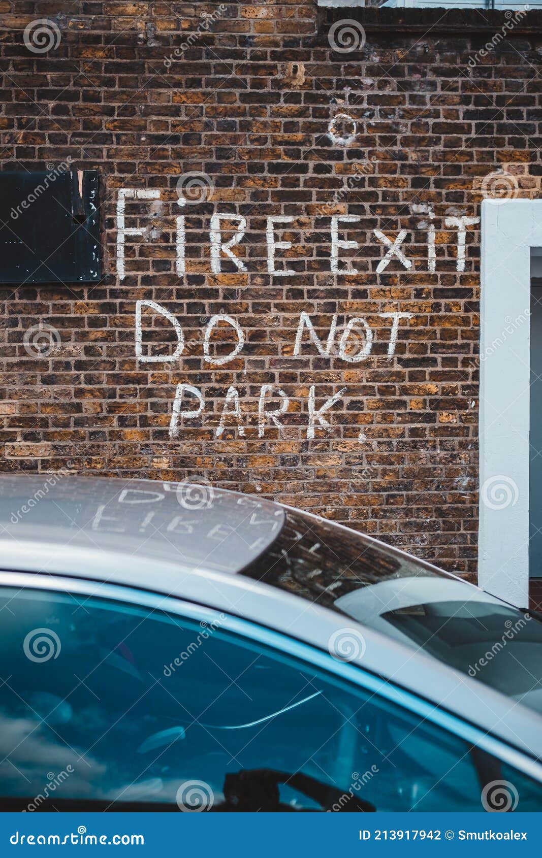 Car Parked in the Front of Fire Exit Sign Sprayed on the Wall Editorial ...