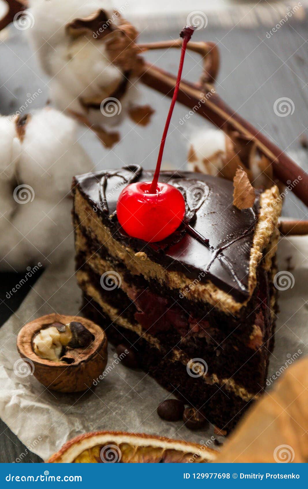 Chocolate Cake with a Bright Cherry. Still Life with Walnut, Coffee ...