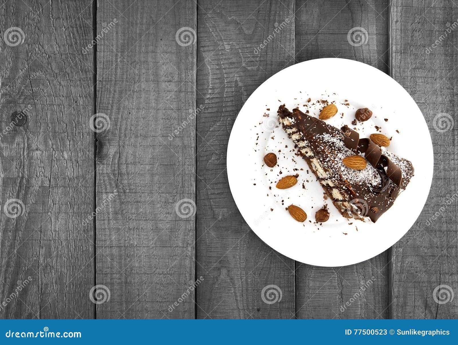 Chocolate Cake Slice with Nut on Plate on Wooden Table, Top View Stock ...